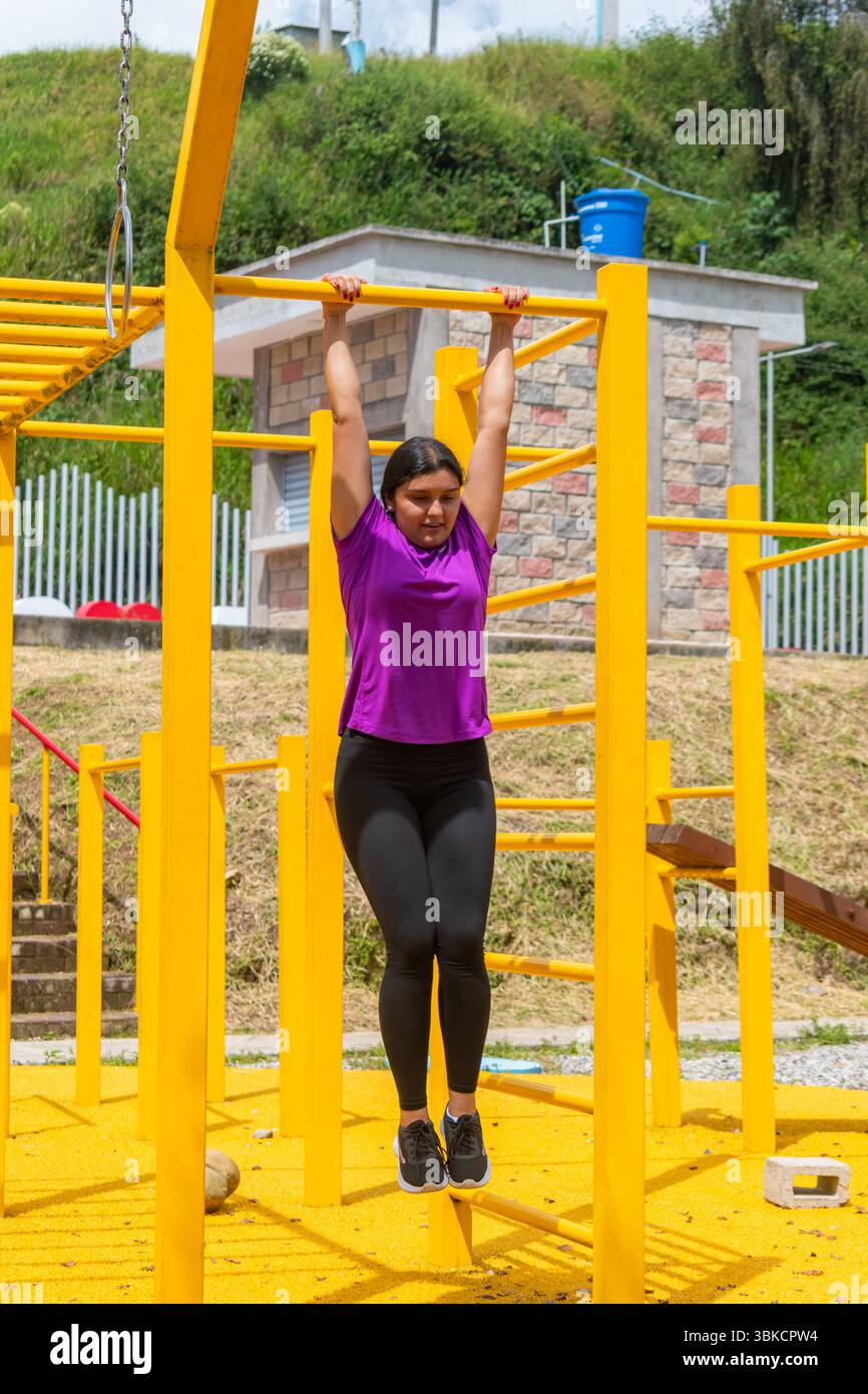 Tired Woman Hanging from Bar After Intense Workout Stock Photo - Alamy