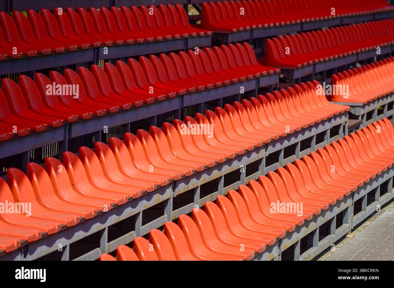 A row of red seats are empty. The seats are arranged in a row, w Stock ...