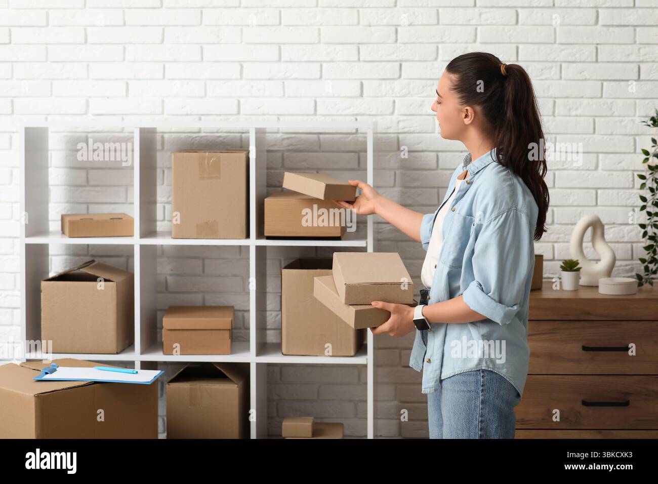 Woman in warehouse taking inventory hi-res stock photography and images ...