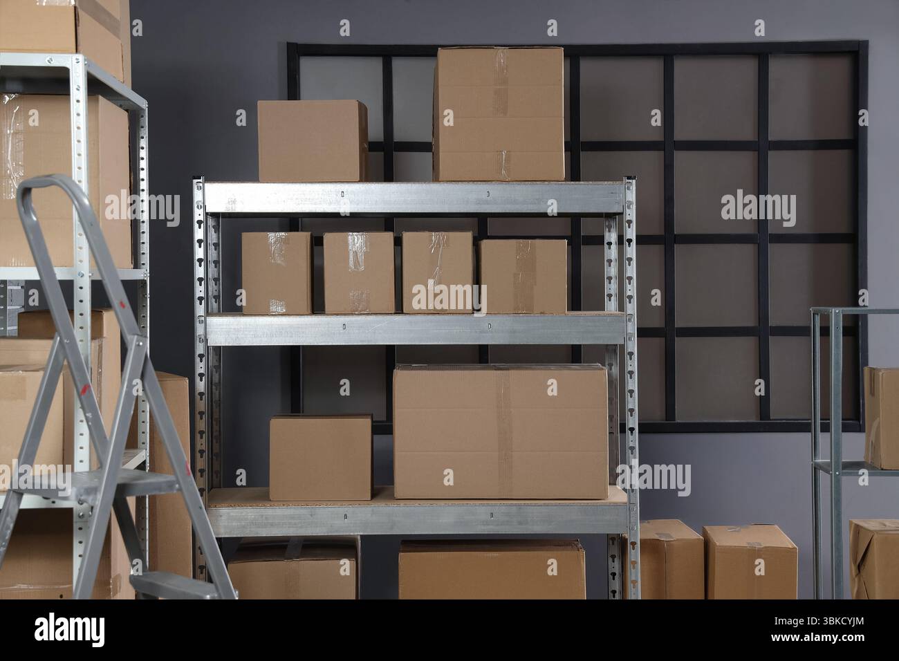 Shelf unit with cardboard boxes in warehouse Stock Photo - Alamy