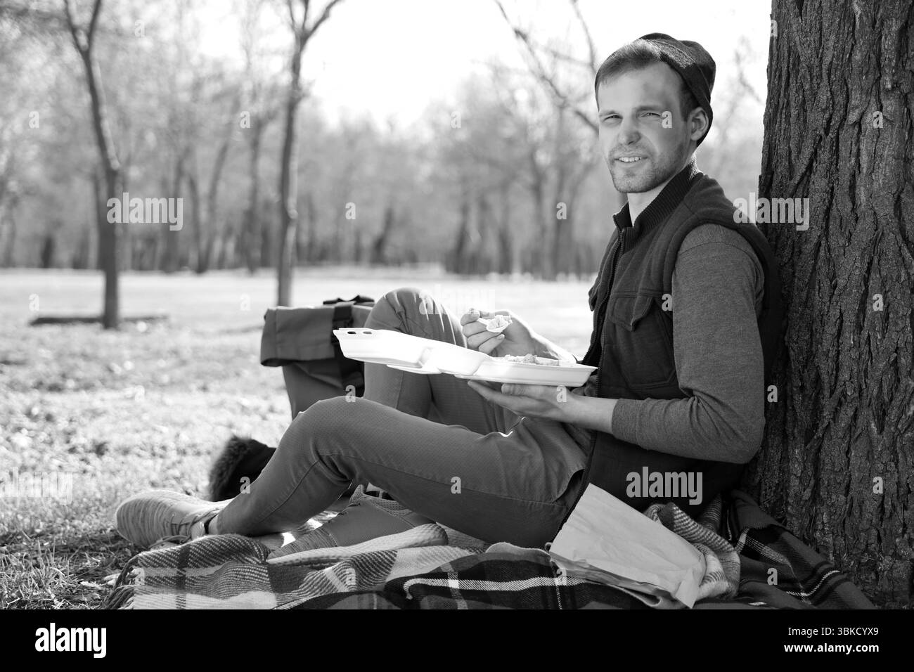 Man eating outside Black and White Stock Photos & Images - Alamy