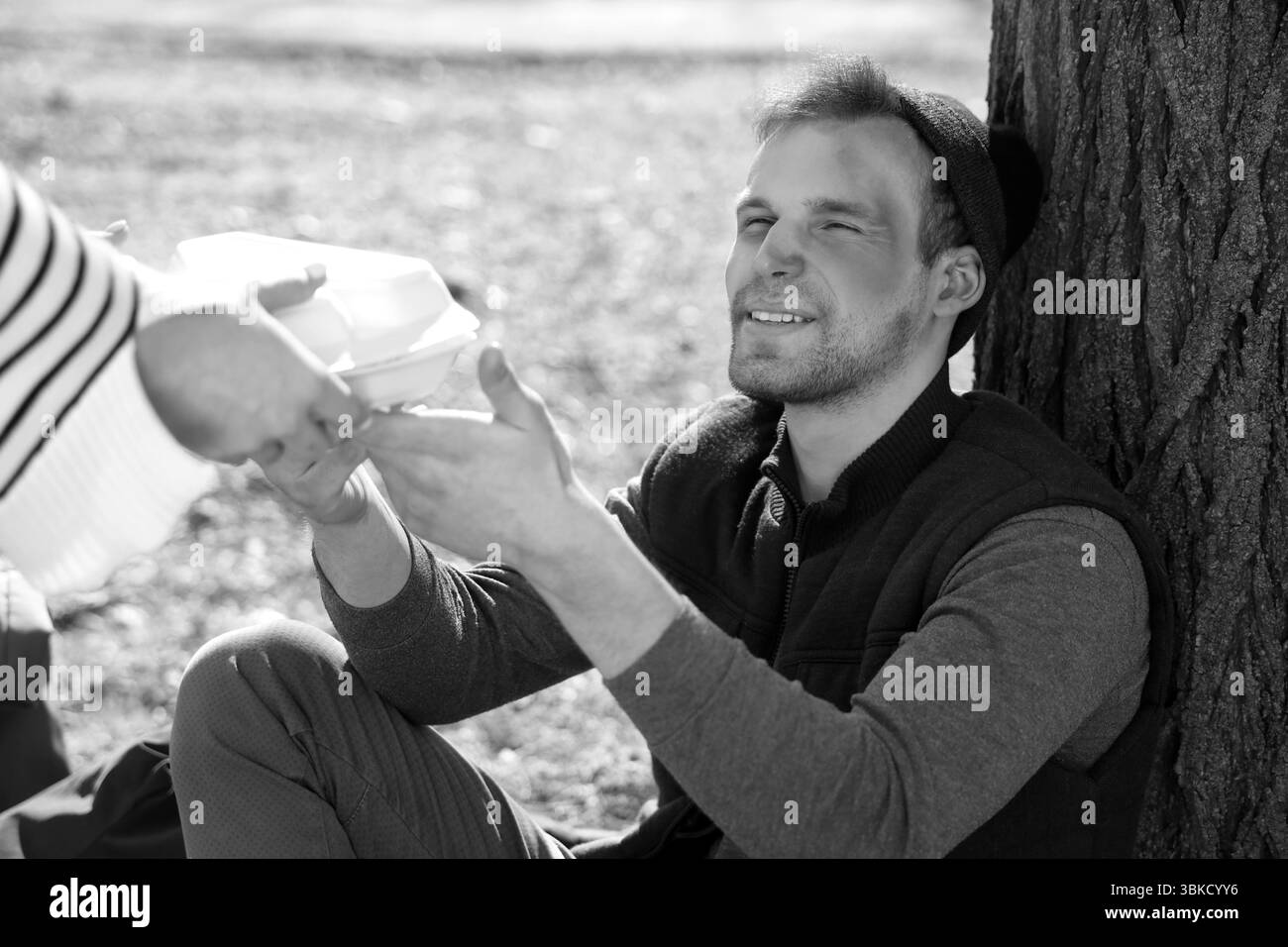 People taking food in Black and White Stock Photos & Images - Alamy