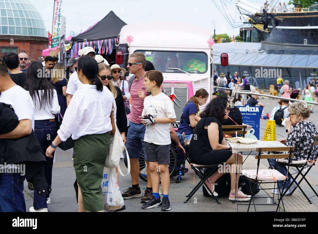 Bustling Outdoor Market Scene with Food Stalls and Social Gatherings ...