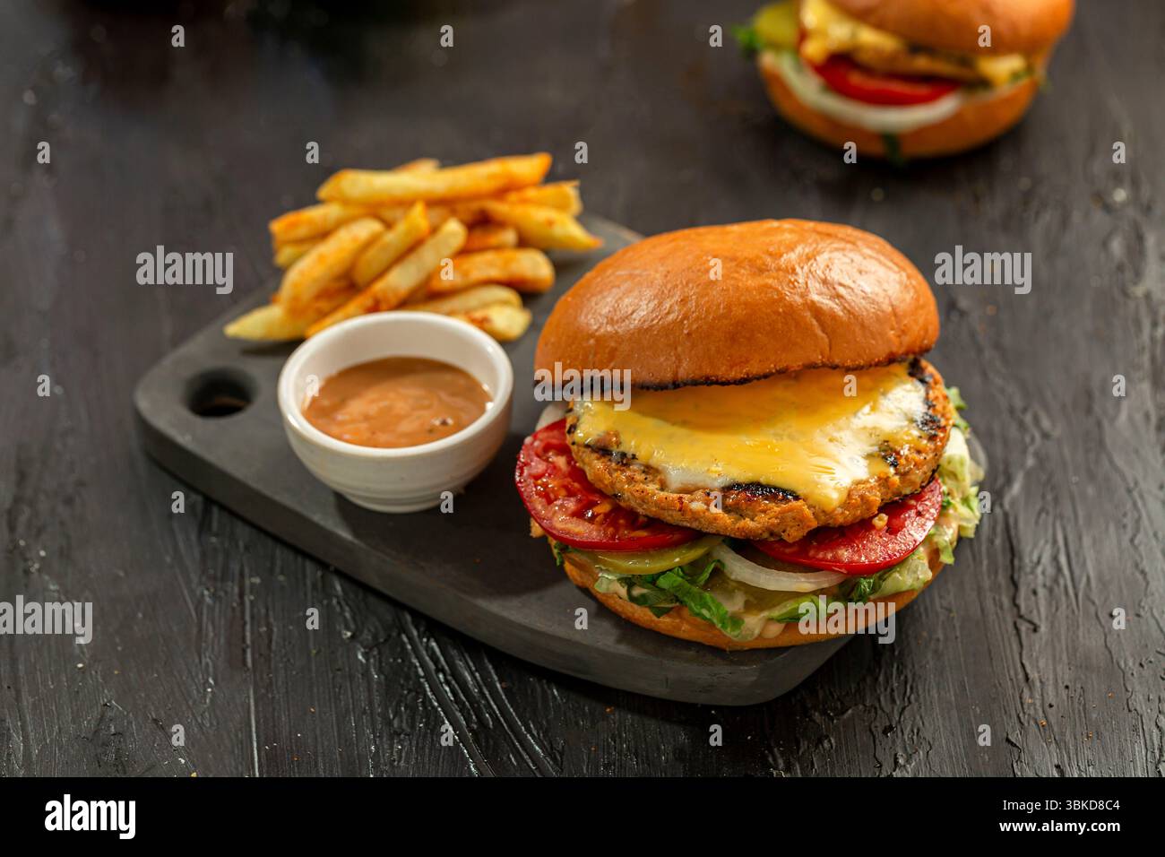 Premium chicken burger with sauce and fries gray background Stock Photo ...