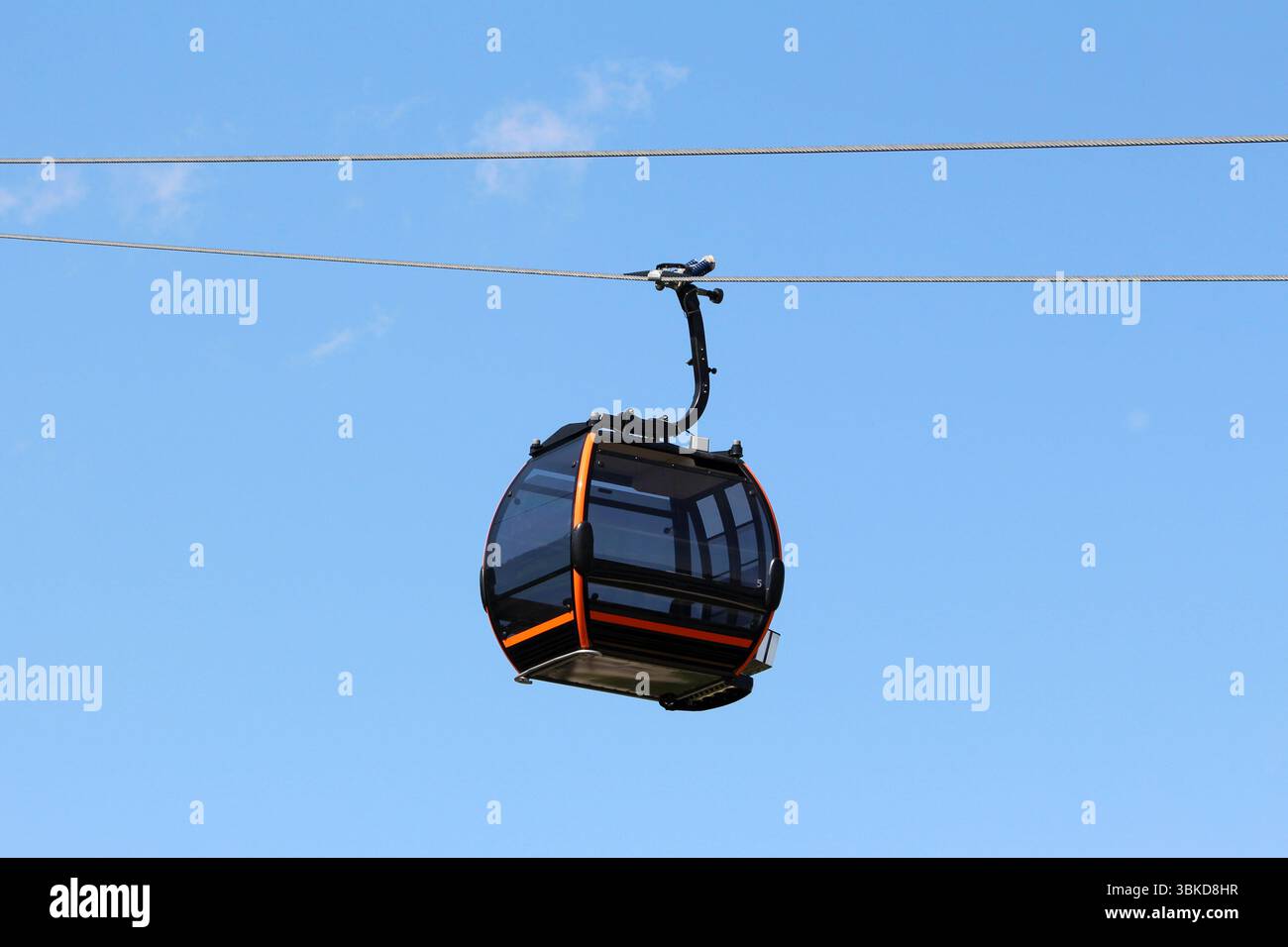 Contemporary gondola lift cabin with tinted windows and orange trim ...