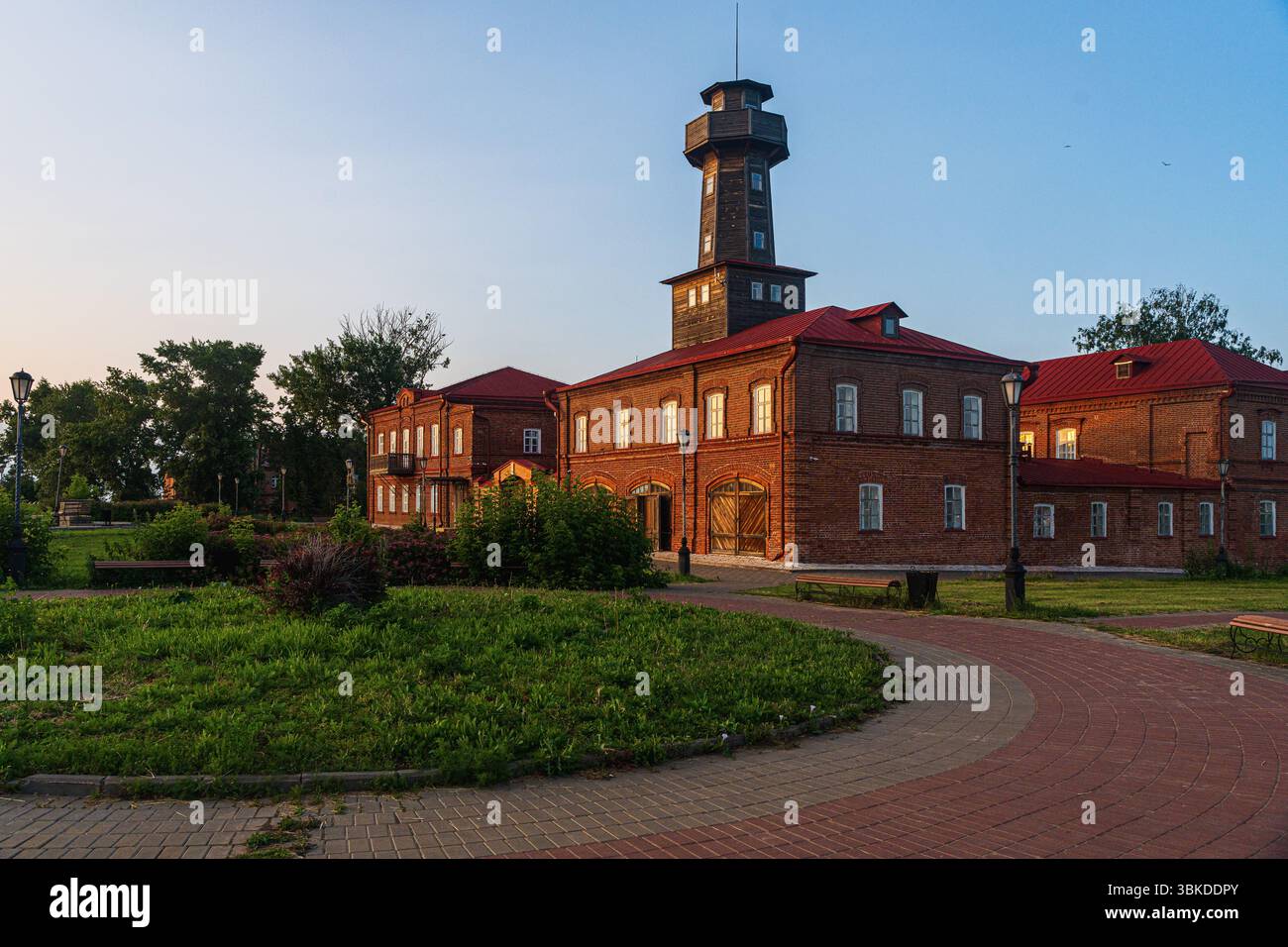 Old red brick fire station with wooden gates and observation tower ...