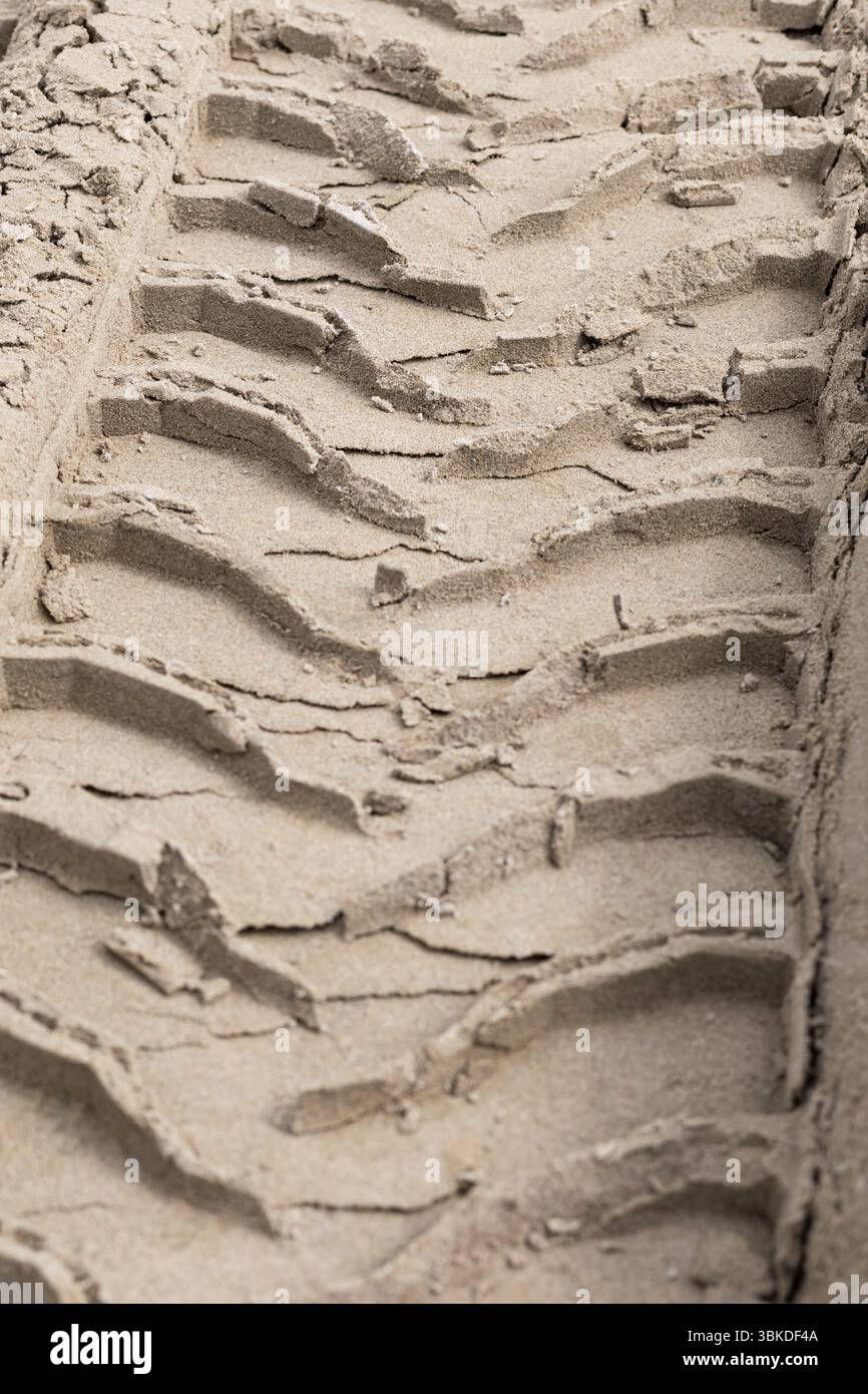 Tire tracks on a sand. Close up wheel marks on the sand. Big tire marks ...