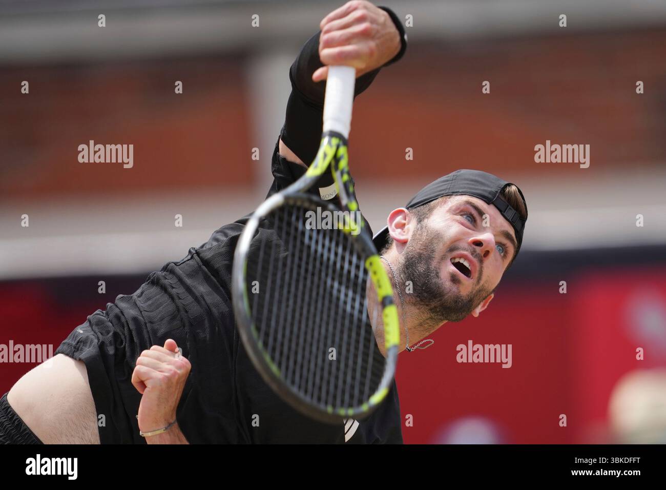 Jacob Fearnley of Britain serves a ball to Jiri Lehecka of the Czech ...