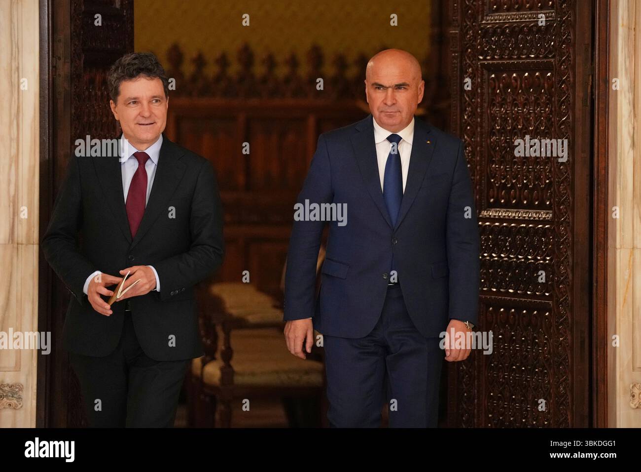 Romanian President Nicusor Dan, left, arrives with Ilie Bolojan, the ...