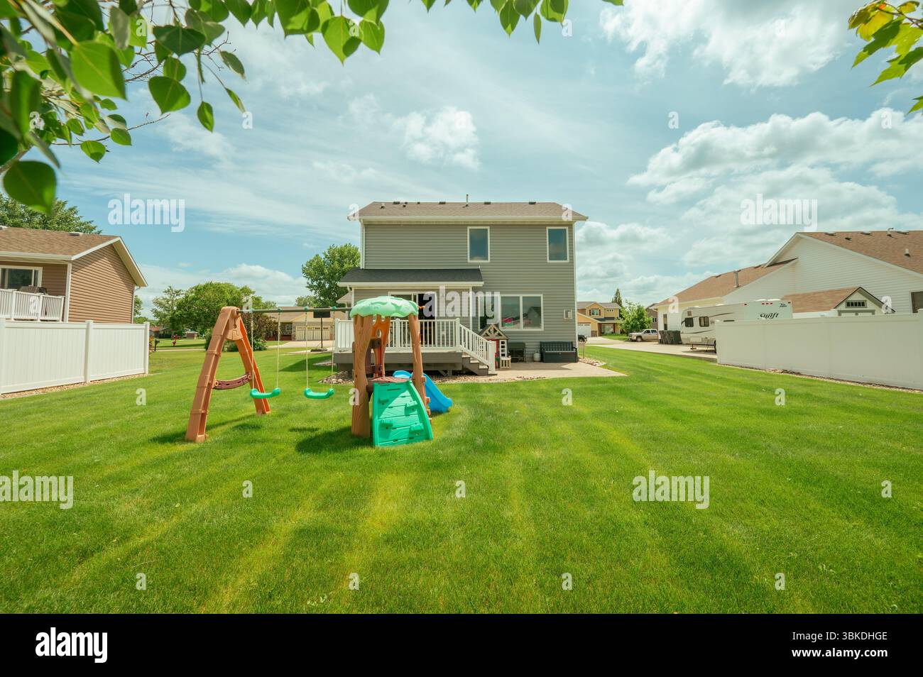 Suburban Backyard With Kids Playground and Green Lawn Stock Photo - Alamy