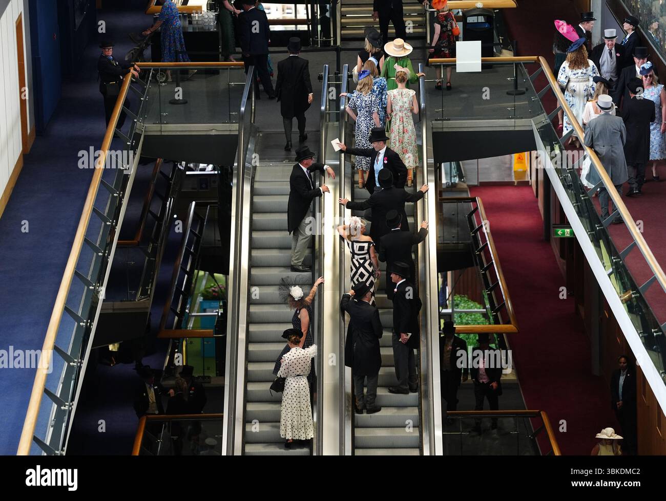 Racegoers using the escalators indoors on day four of Royal Ascot at ...