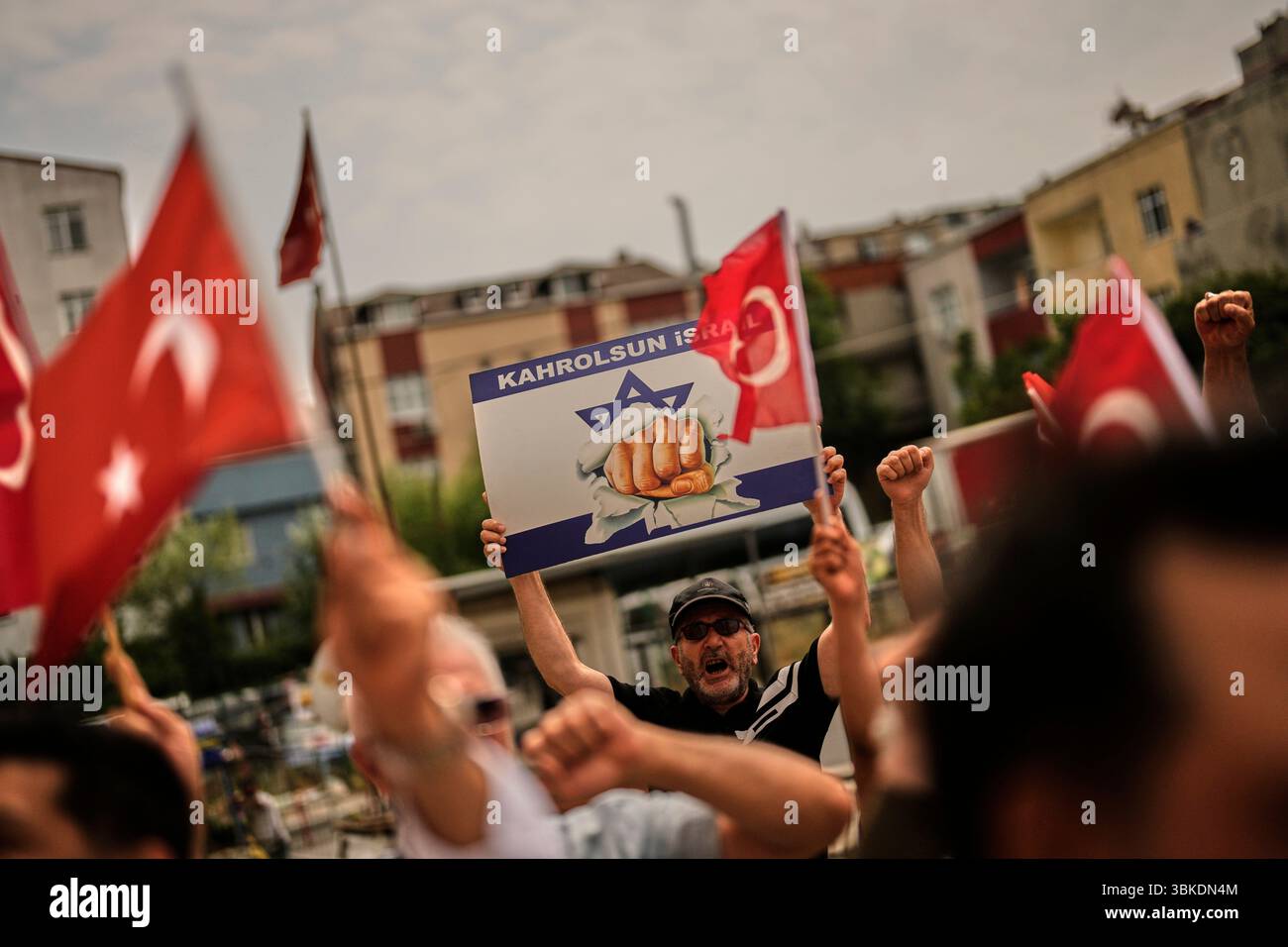 People chant slogans while holding Turkish flags during a protest ...