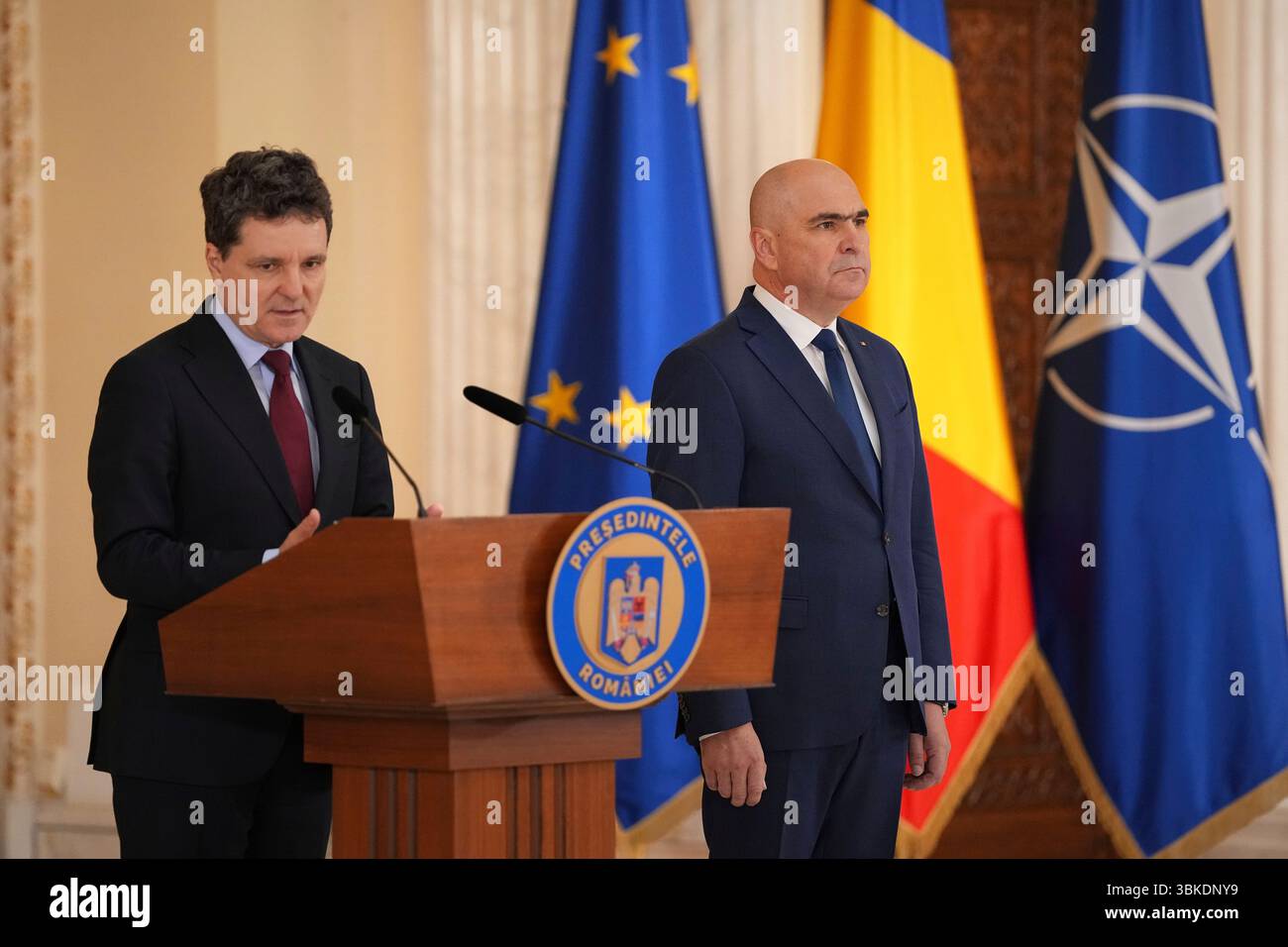 Romanian President Nicusor Dan, left, nominates Ilie Bolojan, the ...