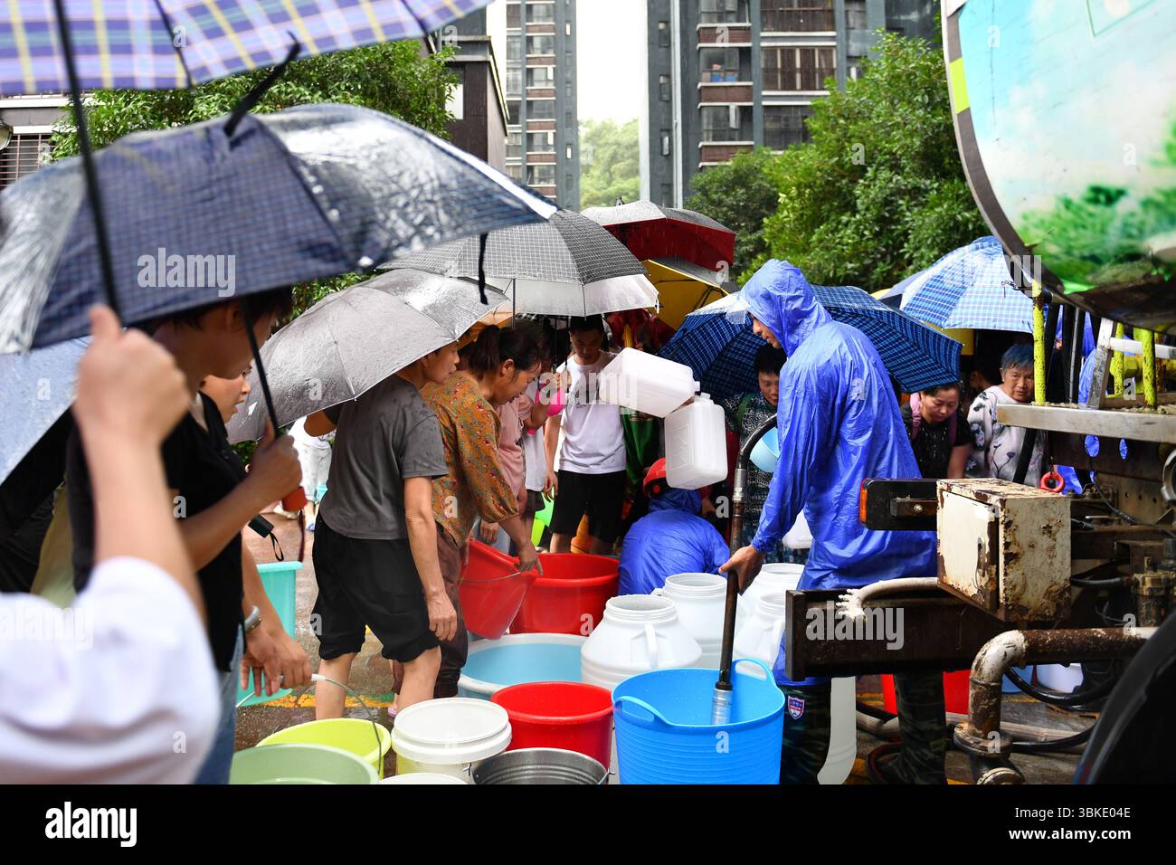 Longshan, China's Hunan Province. 20th June, 2025. Residents get clean ...