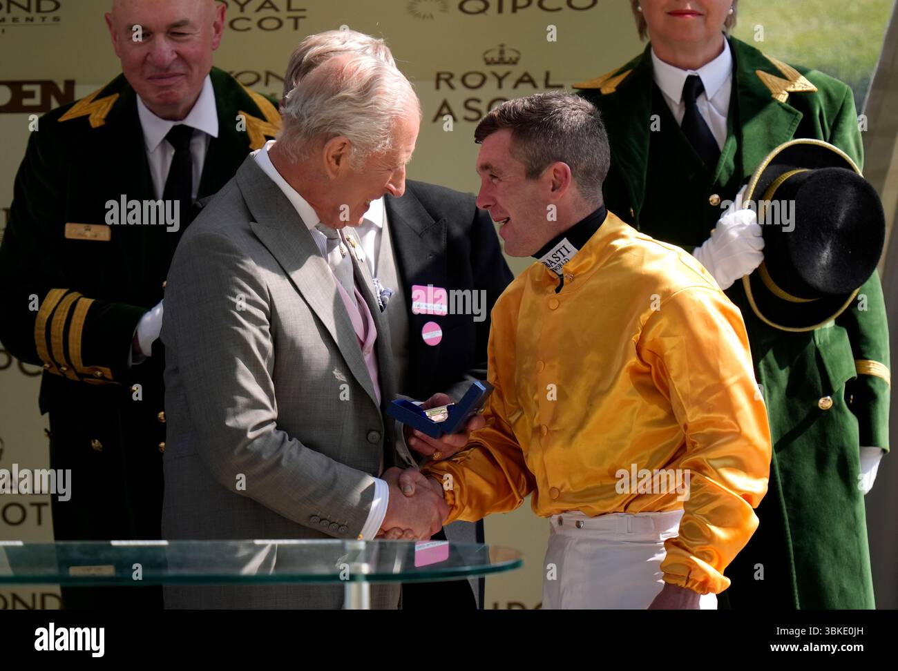 King Charles III presenting a trophy to winning jockey Gary Carroll ...