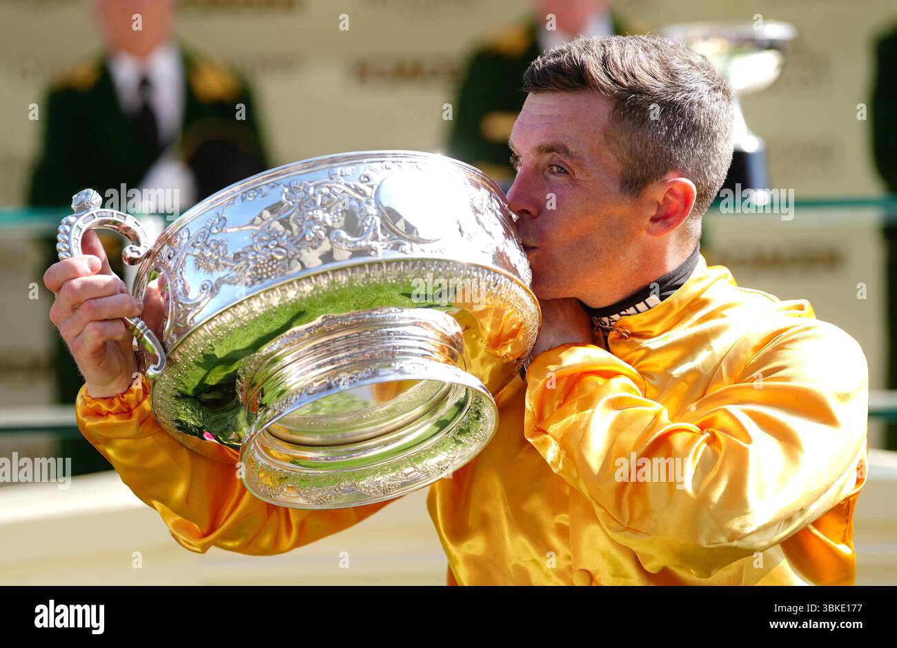 Jockey Gary Carroll celebrates with the trophy after winning the ...