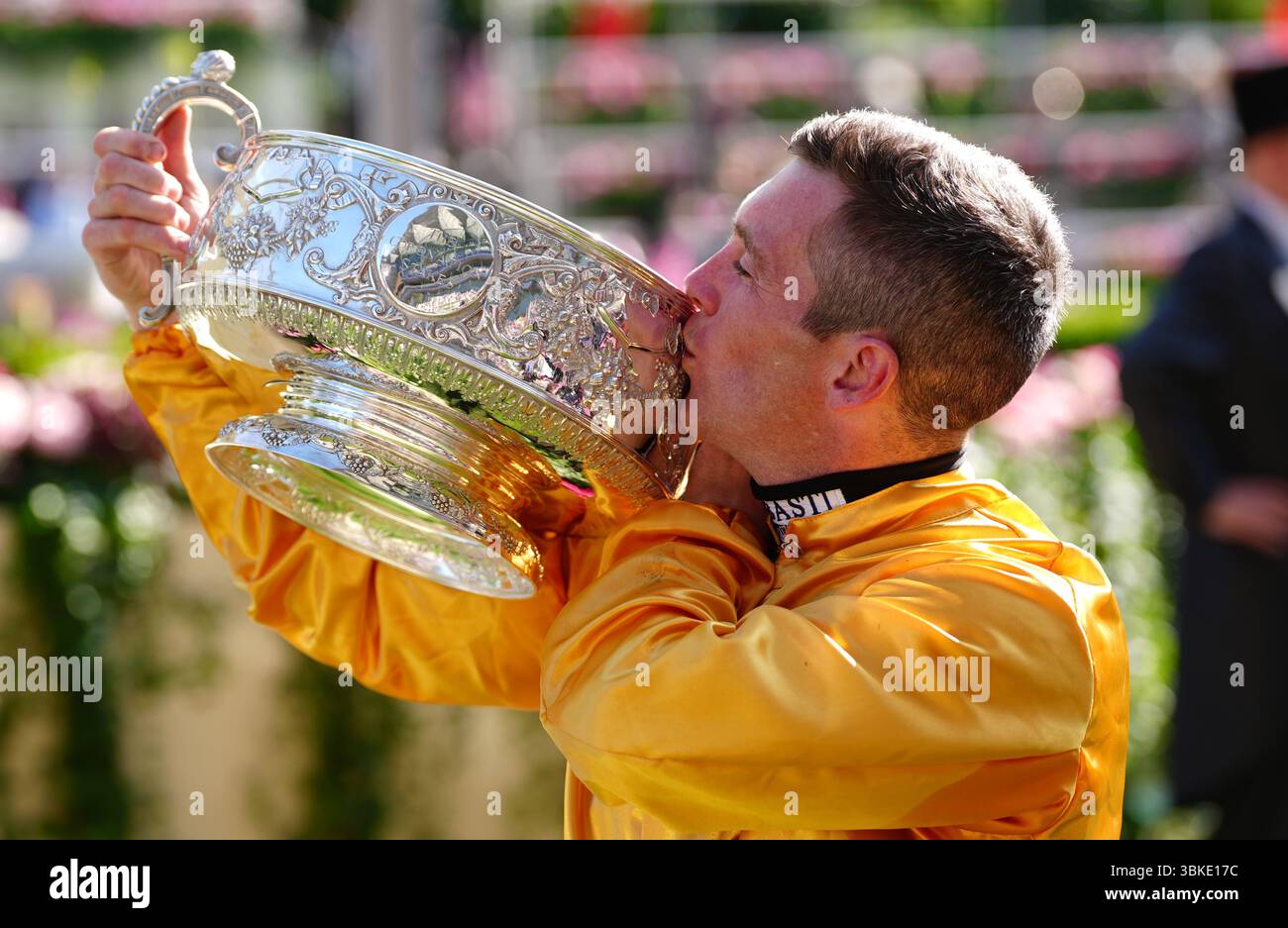 Jockey Gary Carroll celebrates with the trophy after winning the ...