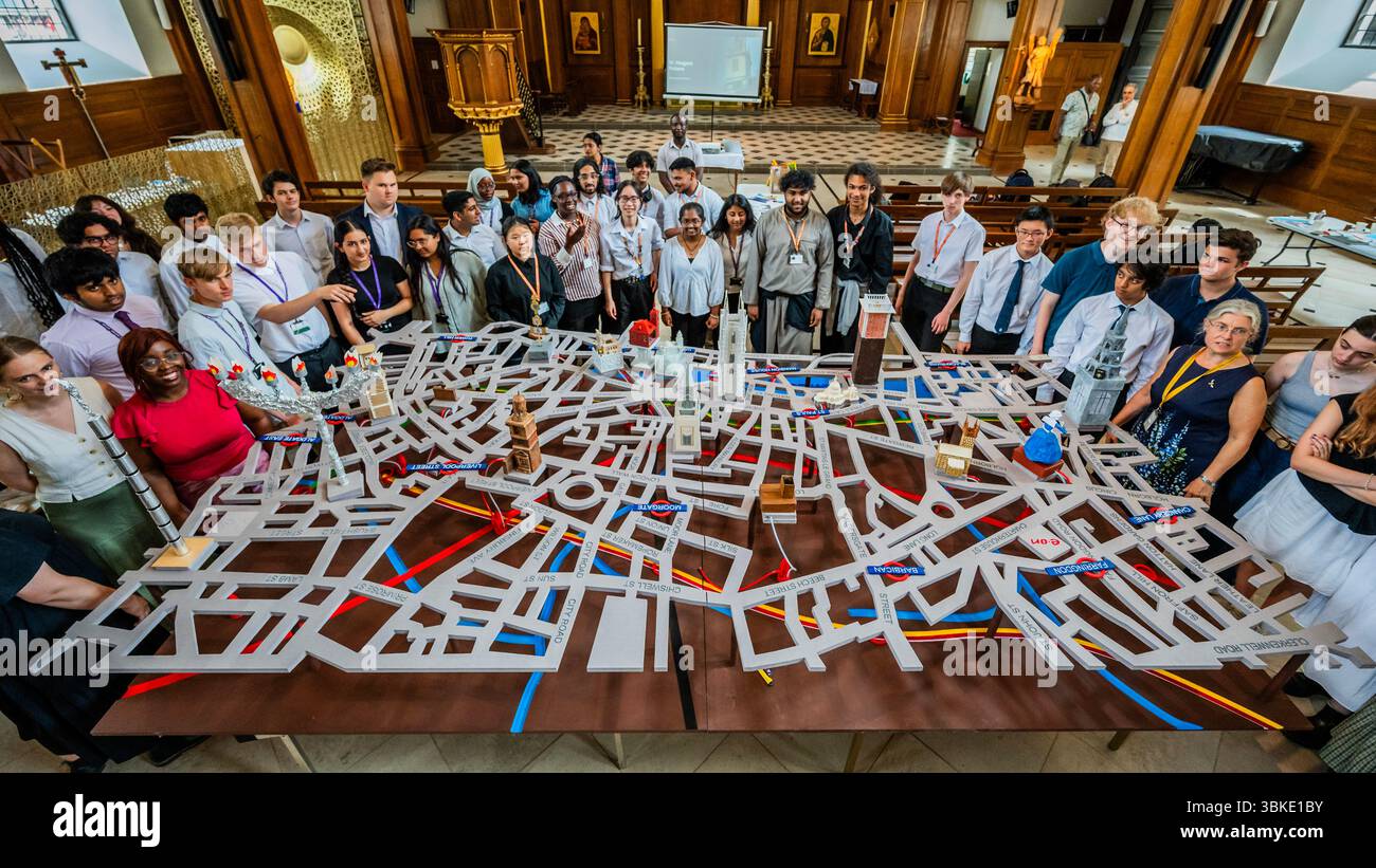 London, UK. 20 Jun 2025. The completed map comes together and then is inspected above and below ...