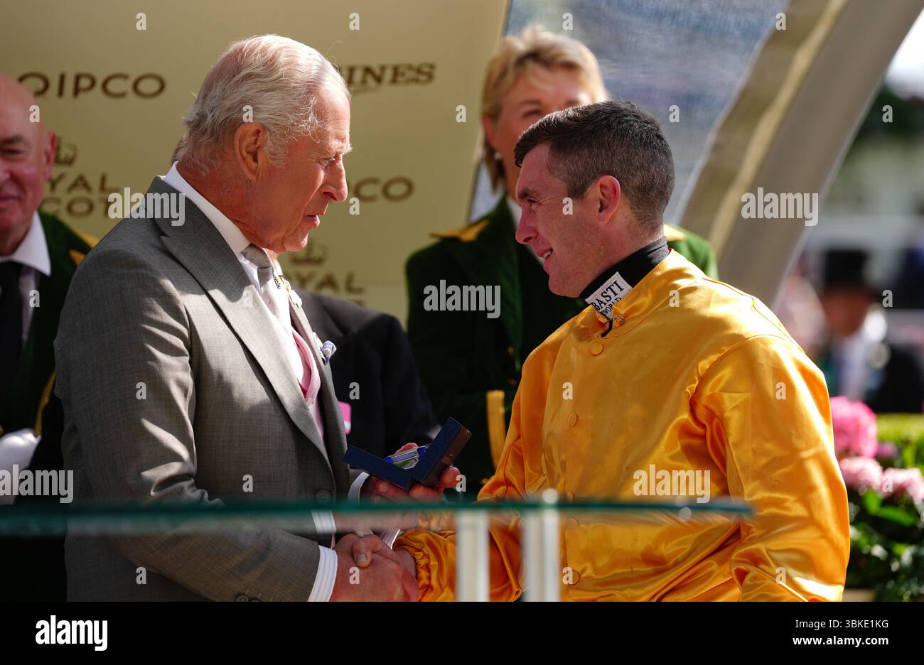 King Charles III presenting a trophy to winning jockey Gary Carroll ...