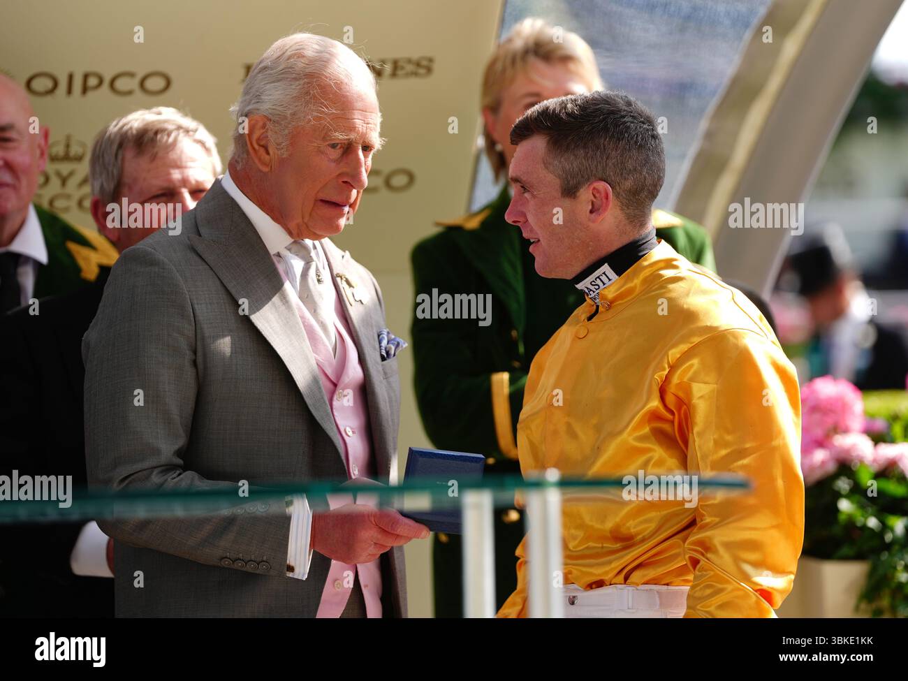 King Charles III presenting a trophy to winning jockey Gary Carroll ...