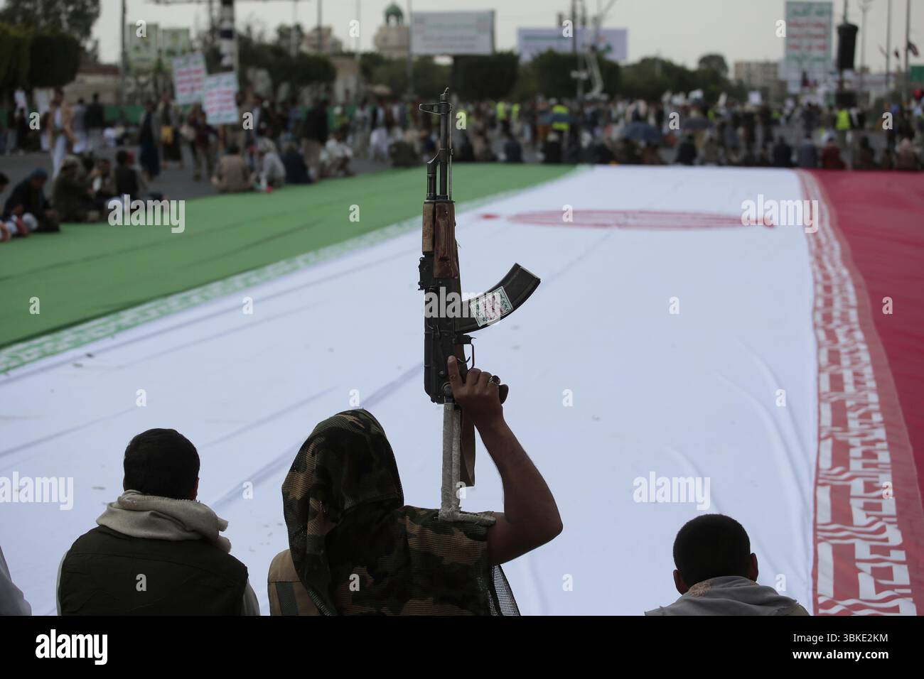 Houthi supporters surround a giant Iranian flag during an anti-U.S. and anti-Israel weekly rally ...