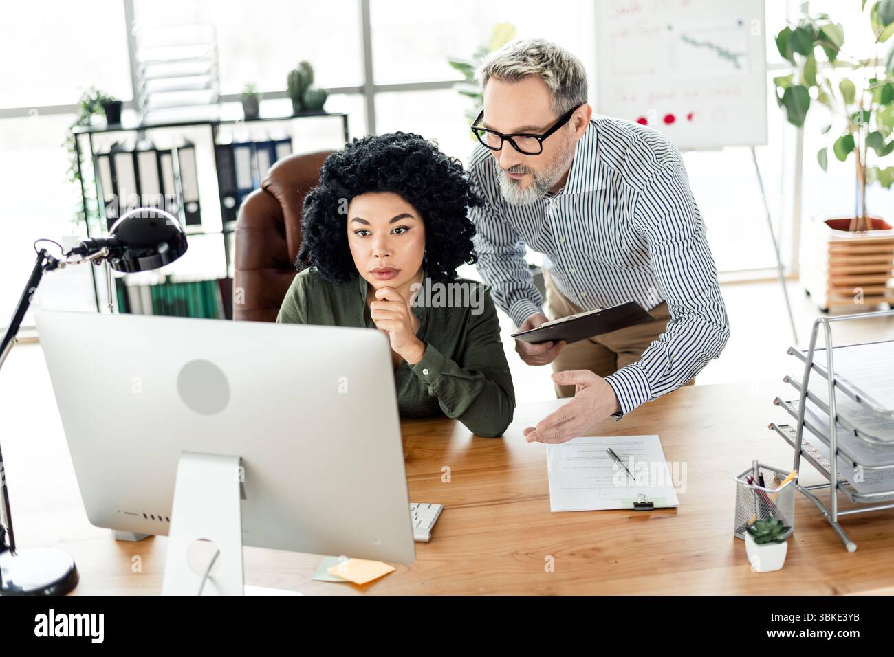 Office teamwork featuring a business meeting with a diverse group of ...