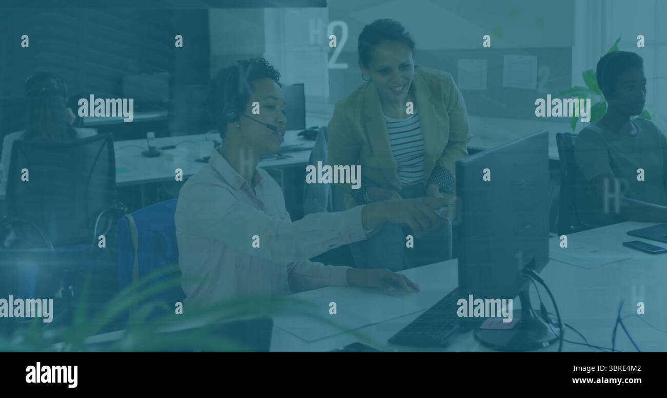 Pointing at computer monitor support agent wearing headset in office ...