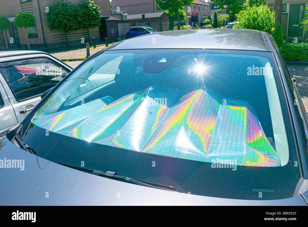 Reflection of the sun in aluminium foil under a car window produces a ...