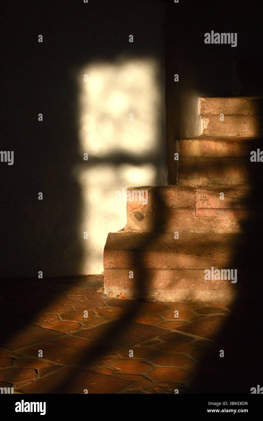Window shadows on an old brick staircase in warm light Stock Photo - Alamy