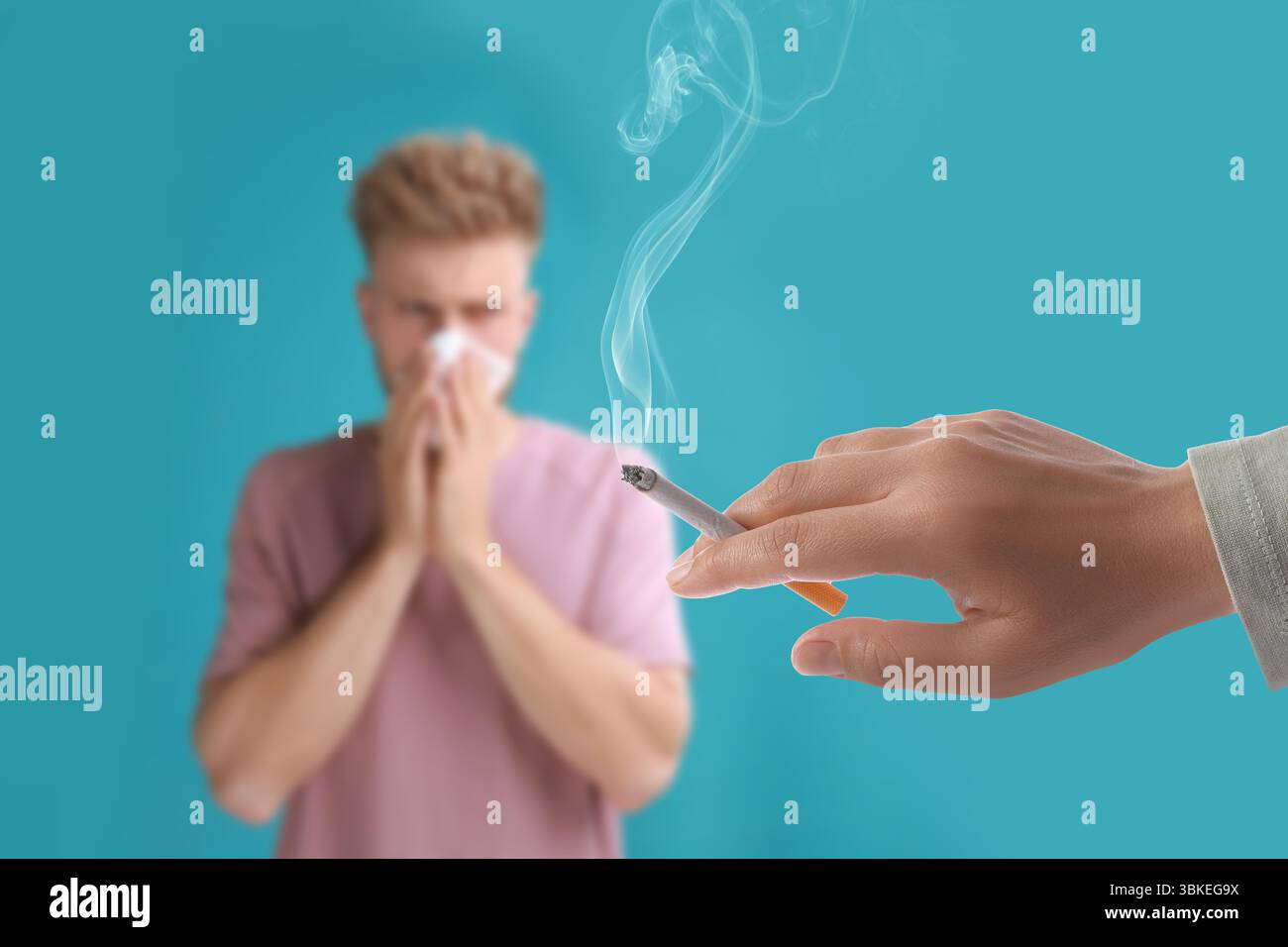 Passive smoking. Man covering his nose with tissue because of woman ...