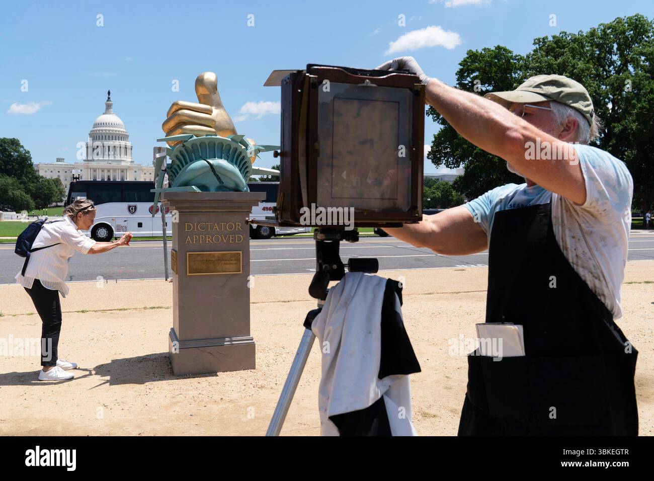 People take pictures of a temporary art installation titled "Dictator ...