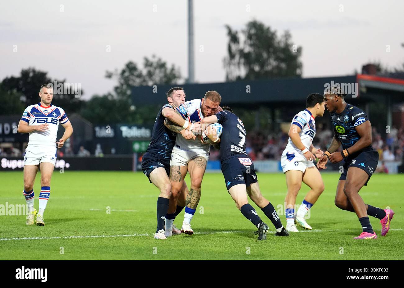 Wakefield Trinity's Josh Griffin tackled by Wigan Warriors' Jake Wardle ...