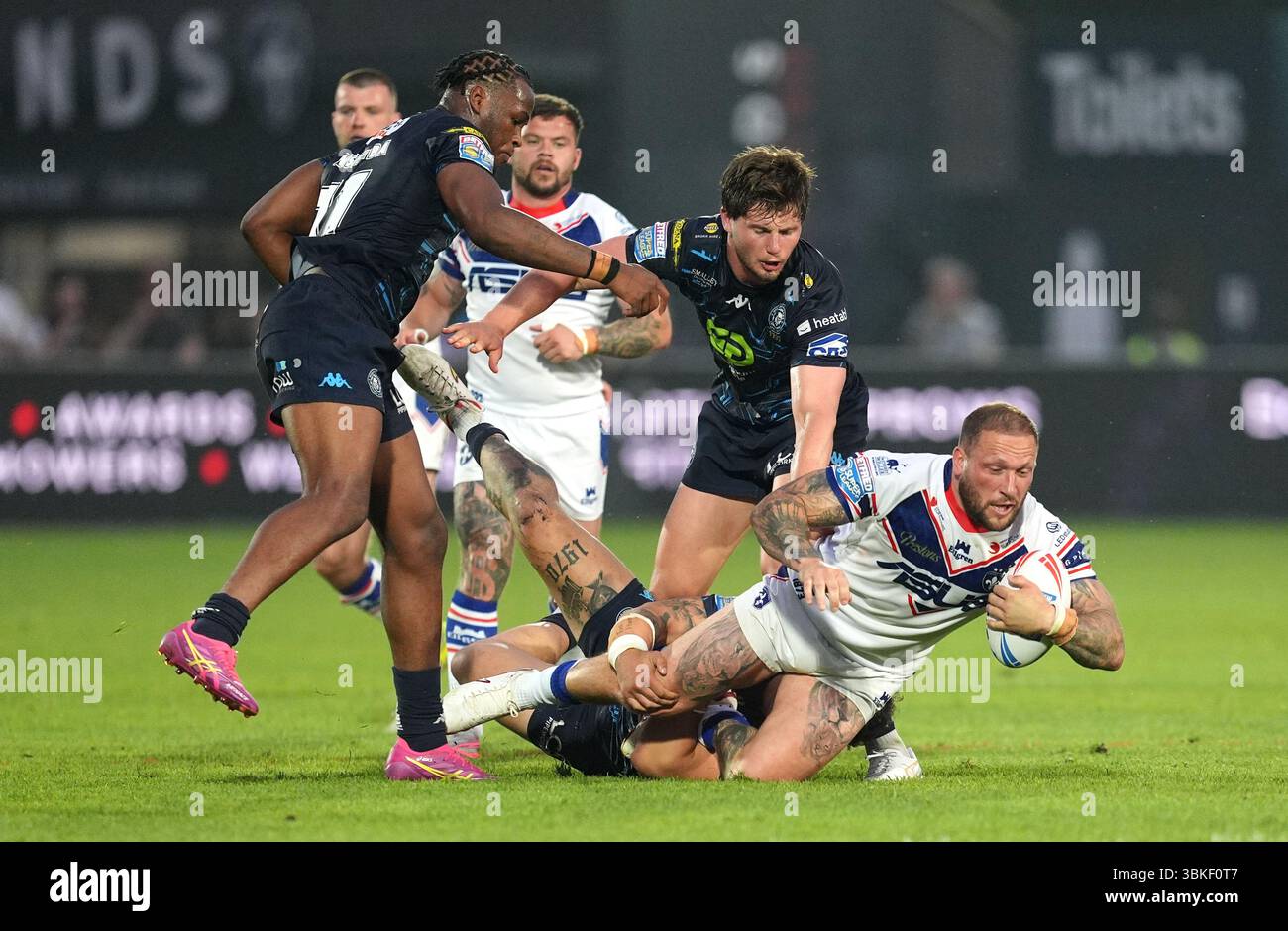 Wakefield Trinity's Josh Griffin tackled by Wigan Warriors' Junior ...
