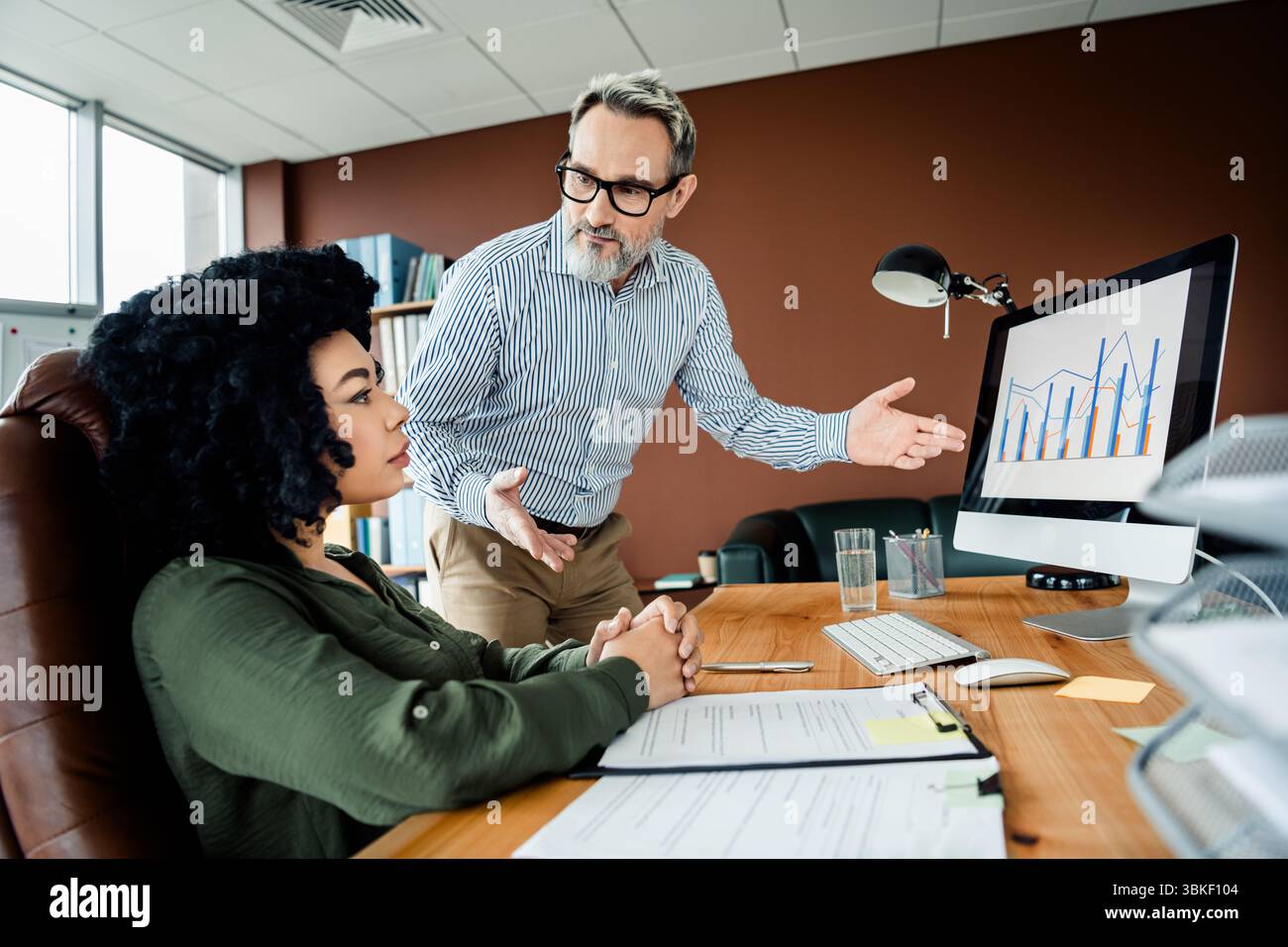 Business professionals collaborating in a workplace discussion with ...