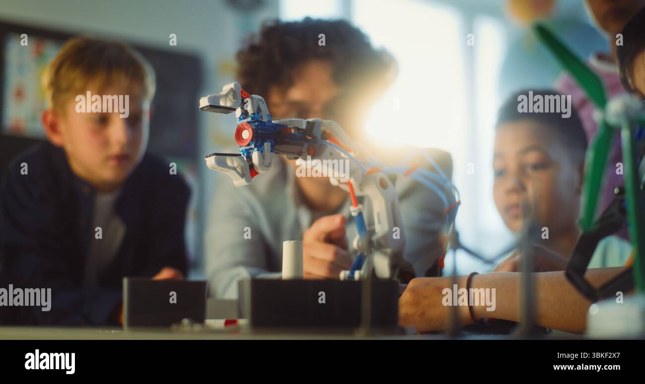 Team of Talented Kids Sitting, Studying Robotic Arm Model with Teacher ...