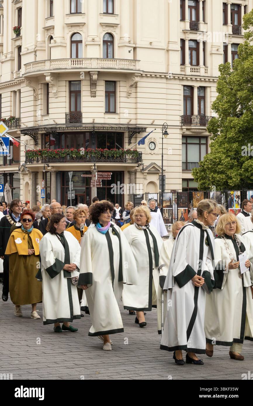 A group of Catholic clergy and lay faithful participate in a Corpus ...