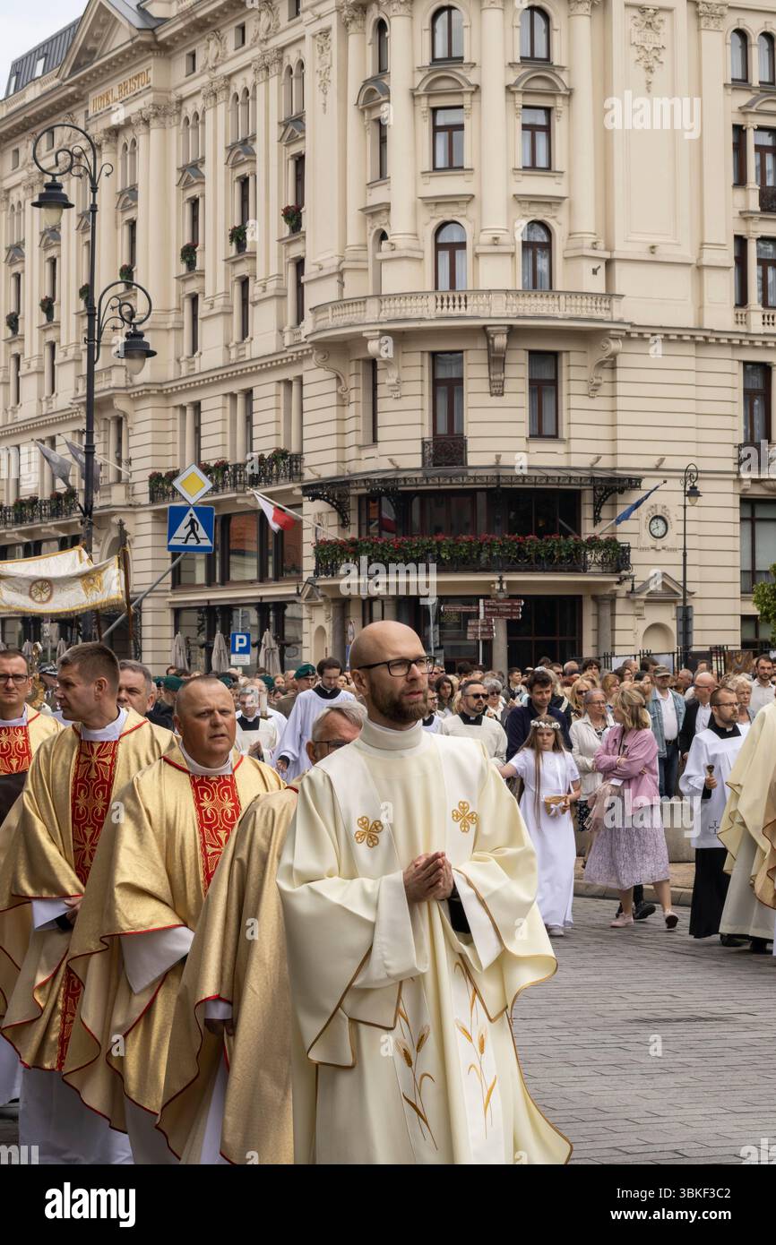 WHO: Catholic clergy and lay worshippers. WHAT: priests carrying the ...
