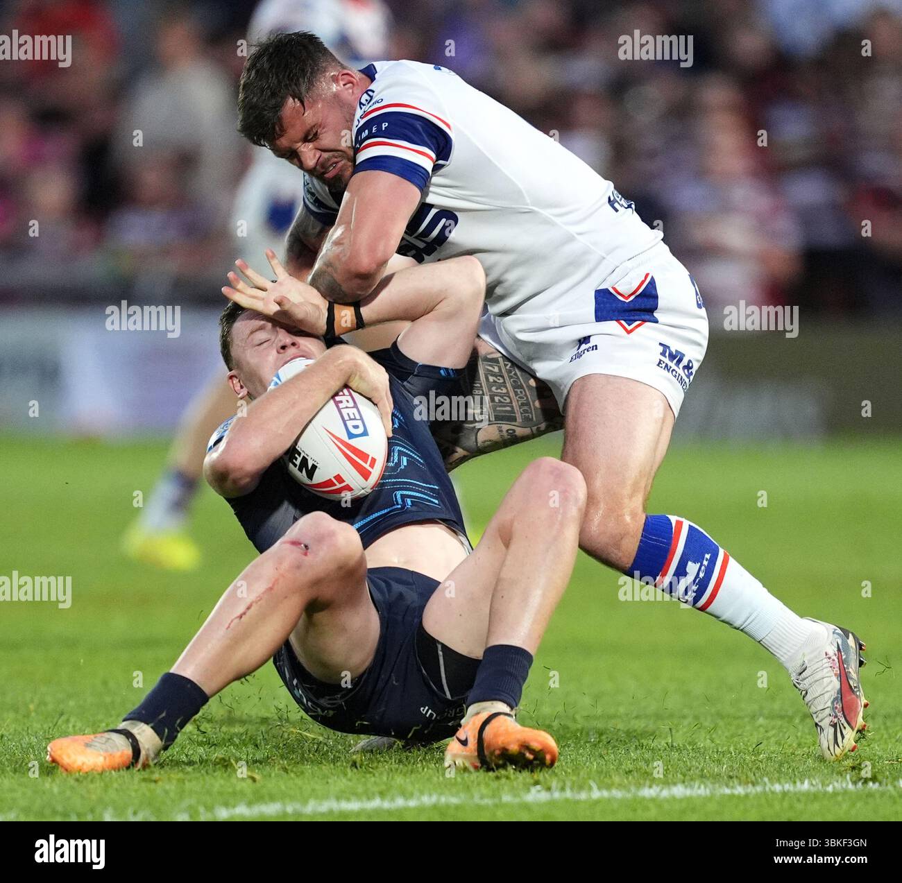 Wigan Warriors' Jai Field tackled by Wakefield Trinity's Liam Hood ...