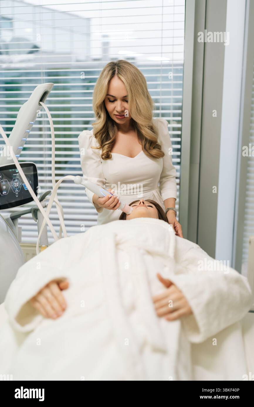 Vertical portrait of aesthetic professional performing mesotherapy ...
