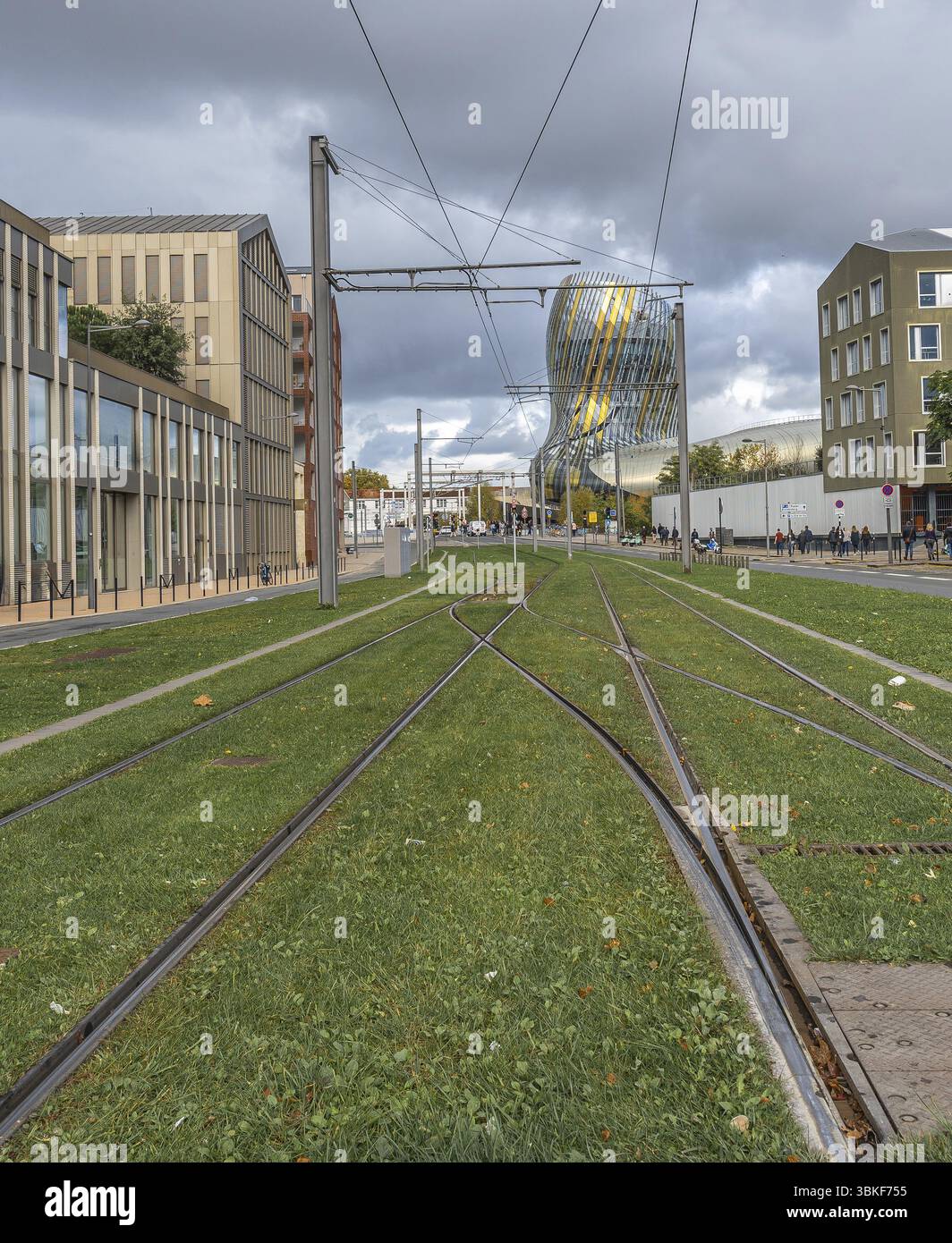 Grass-covered tram tracks crossing in bordeaux city center, with the ...