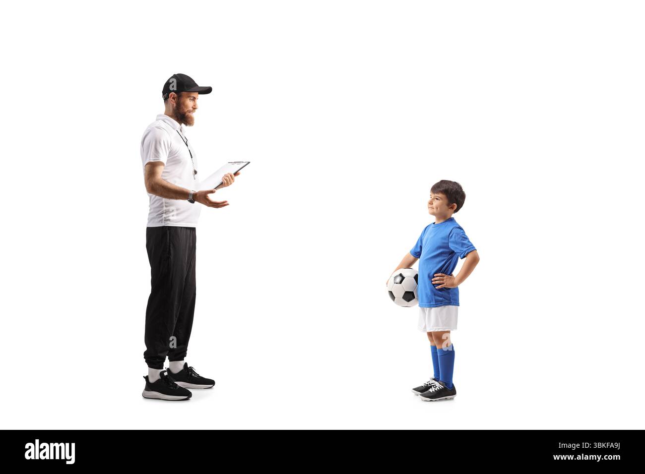 Football coach talking to a boy with a ball isolated on white ...