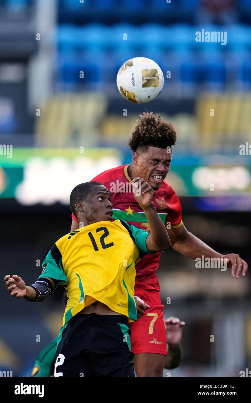 Jamaica midfielder Dwayne Atkinson, left, and Guadeloupe midfielder ...