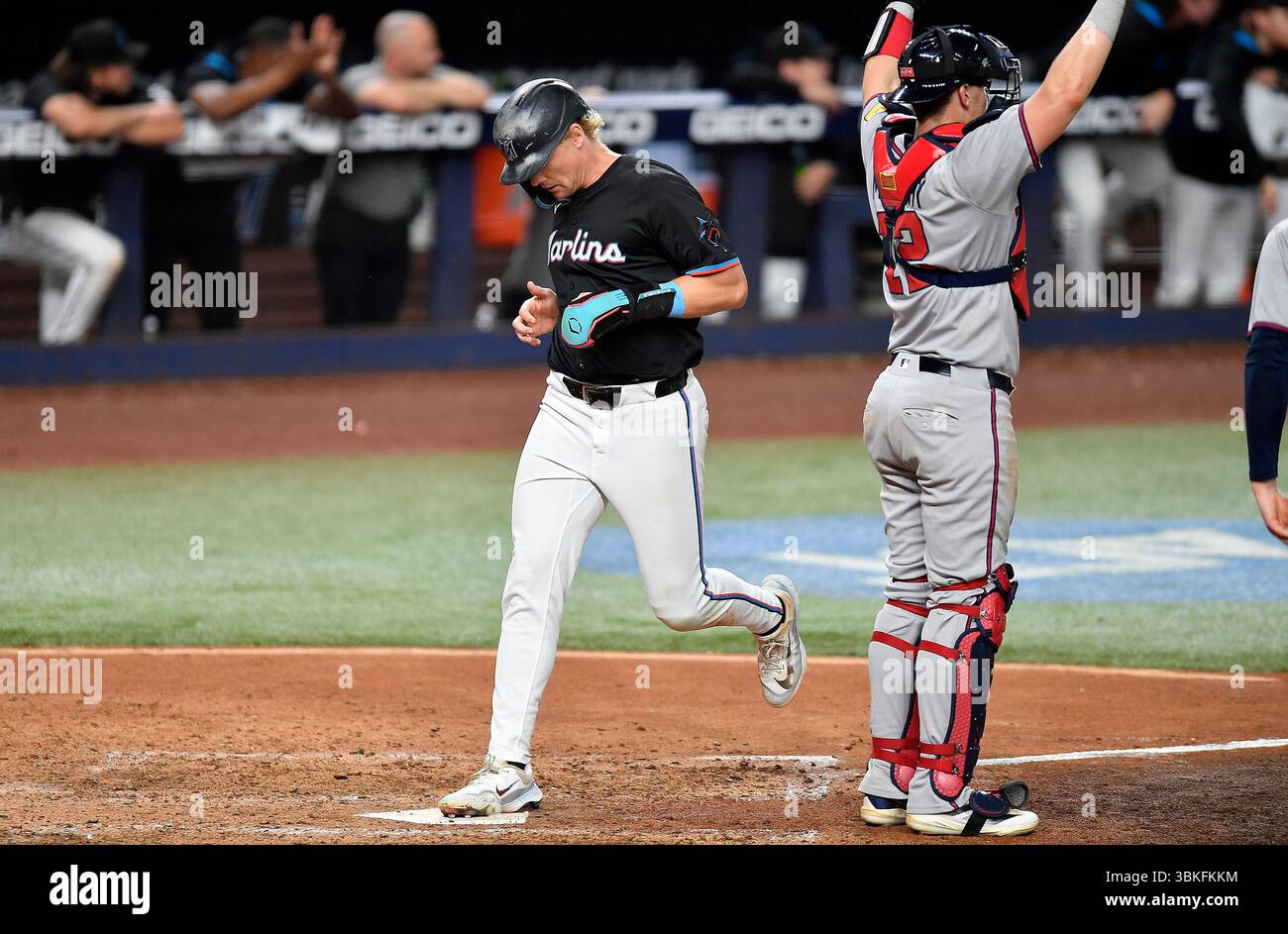 Miami Marlins' Kyle Stowers, left, scores as Atlanta Braves catcher ...