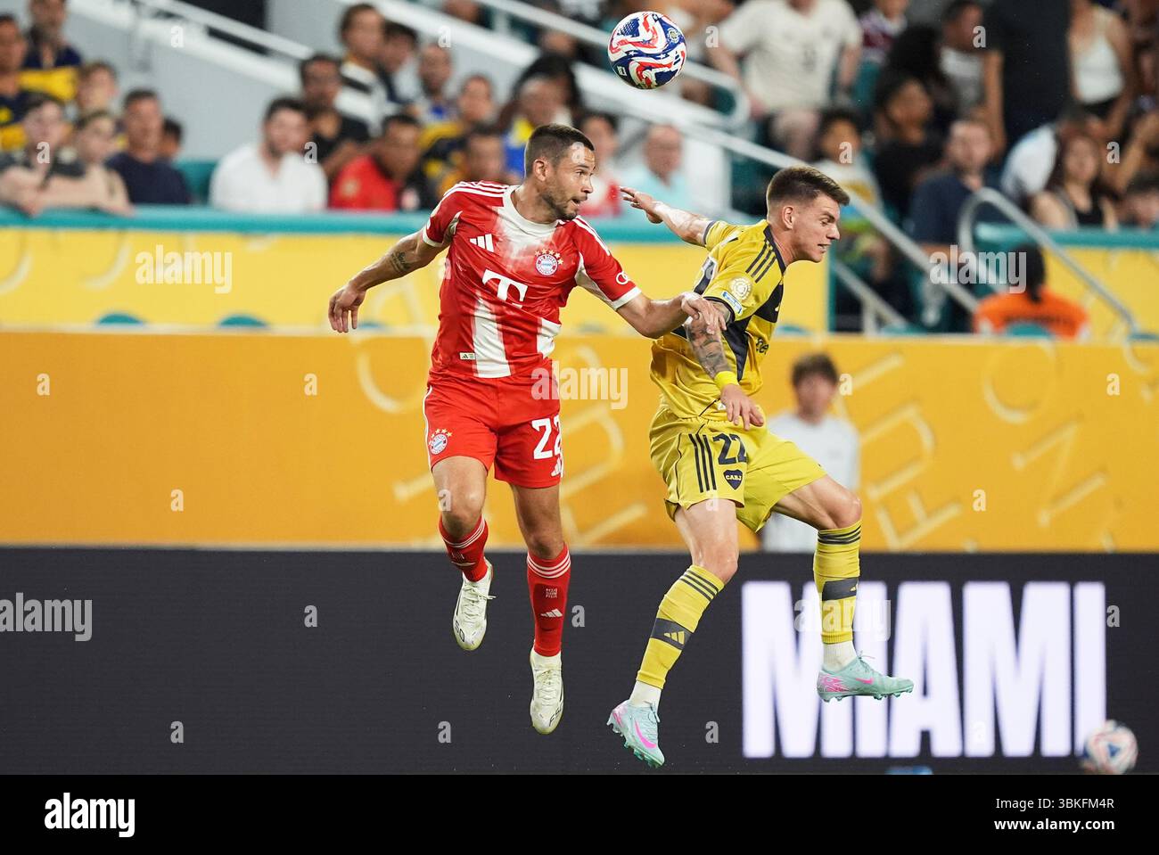 Boca Juniors' Kevin Zenon, right, and Bayern Munich's Raphael Guerreiro jump for a header during ...