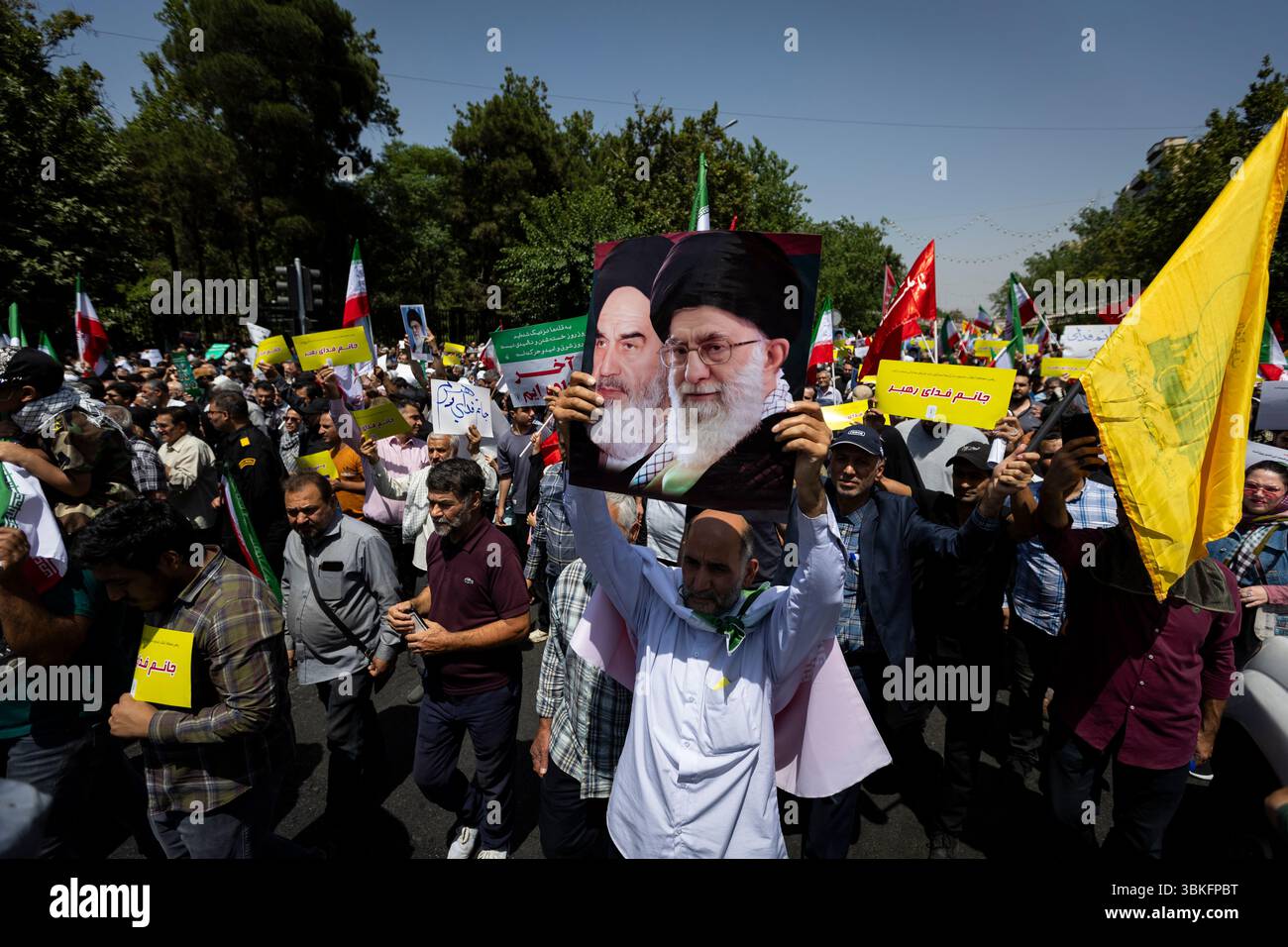 Tehran, Iran. 20th June, 2025. 6/20/2025 An Iranian protester holds a ...