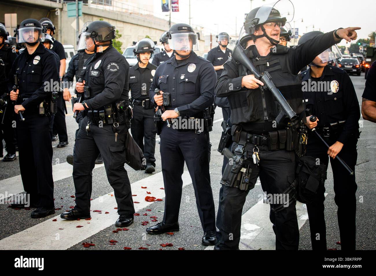 Los Angeles Police Department officers in riot gear, one holding a ...