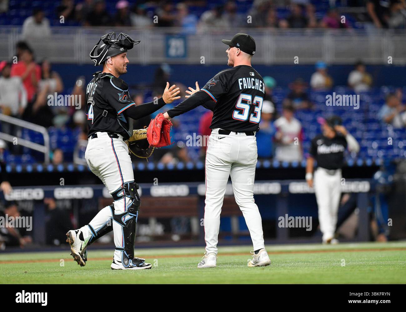 Miami Marlins catcher Agustín Ramírez, left, and pitcher Calvin Faucher ...