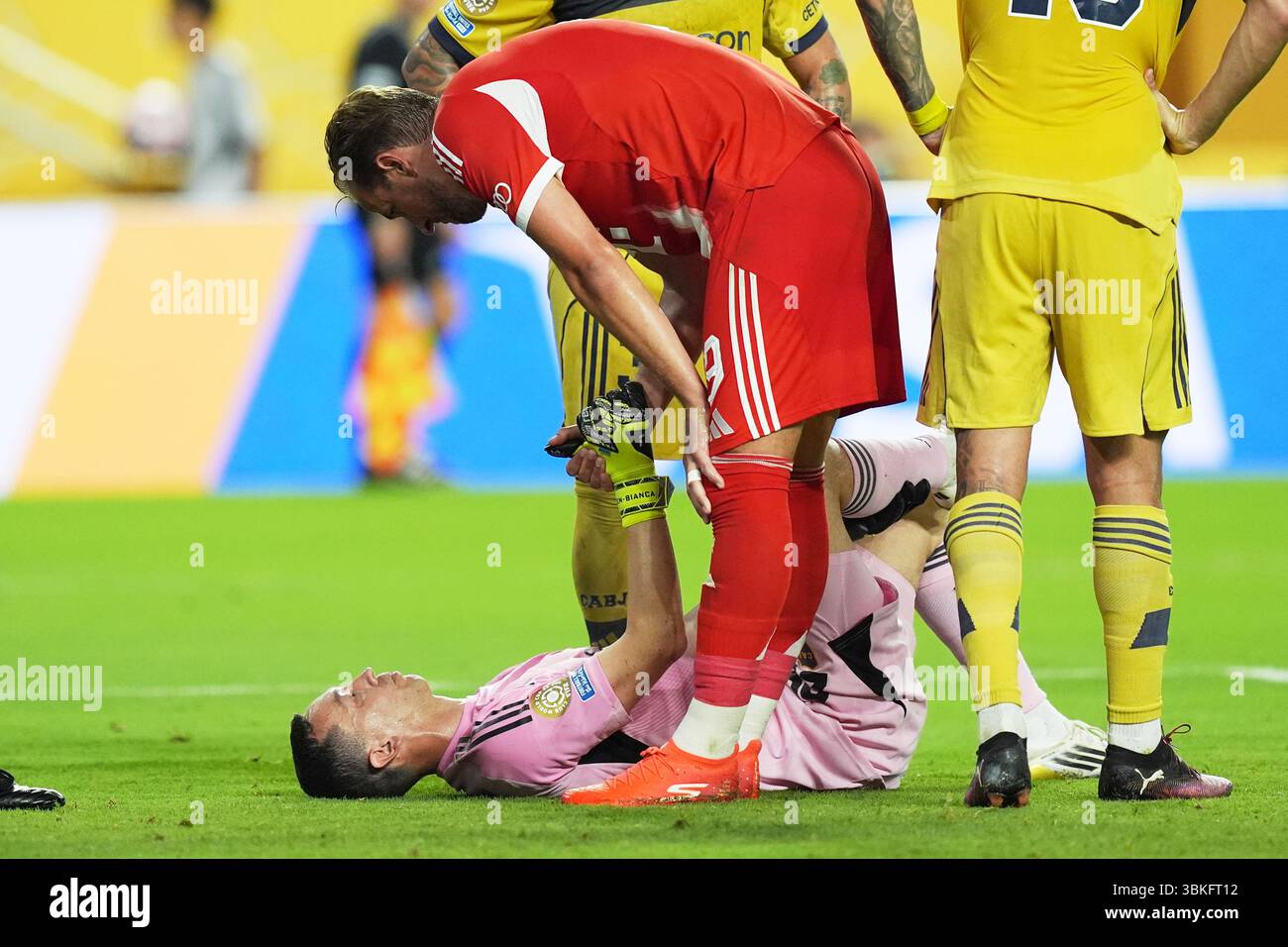 Bayern Munich's Harry Kane, top, checks on Boca Juniors' goalkeeper ...