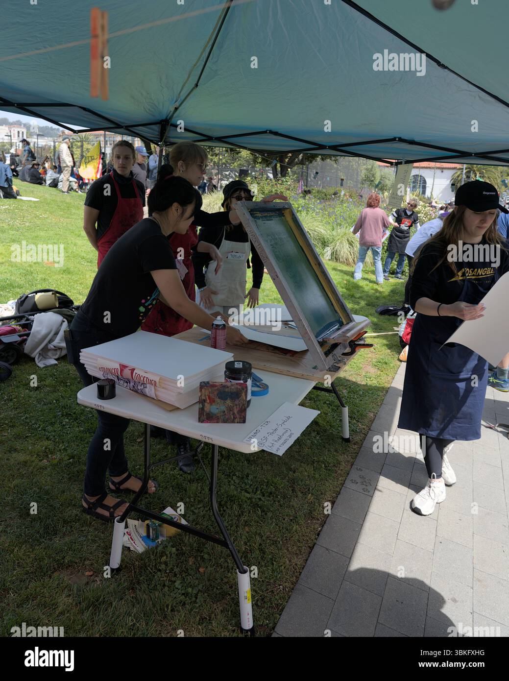 Protestors screen print signs on site at Mission Delores Park during ...