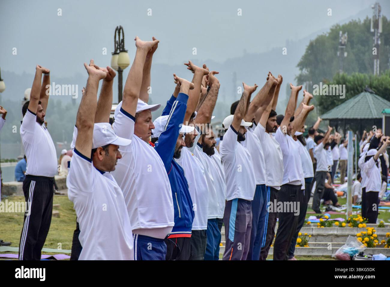 Participants perform yoga during a mass yoga session on International ...